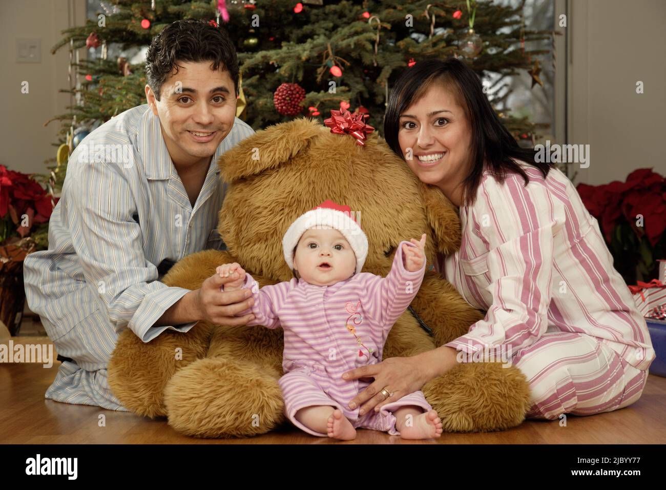 Hispanic parents and baby on Christmas Stock Photo - Alamy