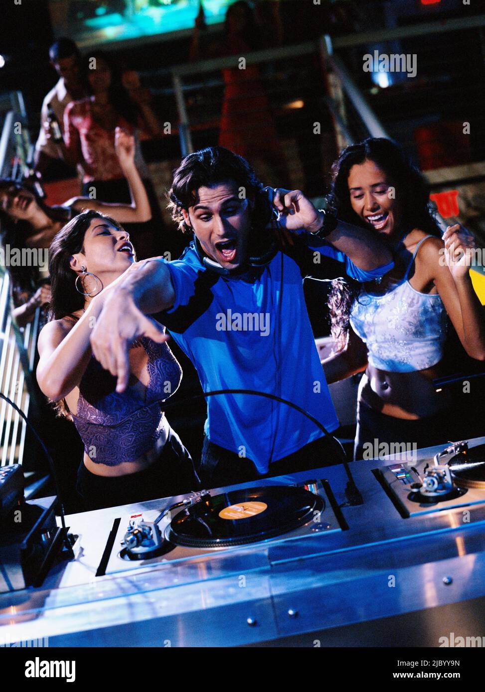 Male DJ dancing with two women Stock Photo - Alamy