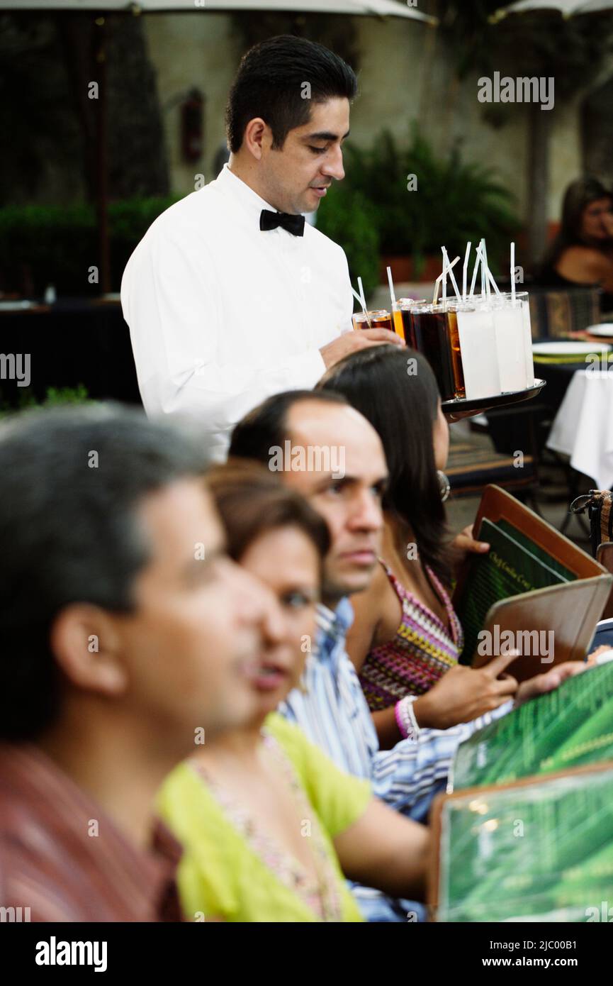 Waiter serving drinks at a restaurant Stock Photo - Alamy