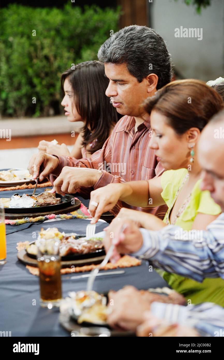 Family eating at the table Stock Photo - Alamy