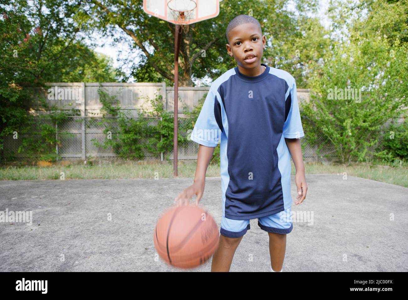 Children bouncing basketball hi-res stock photography and images - Alamy