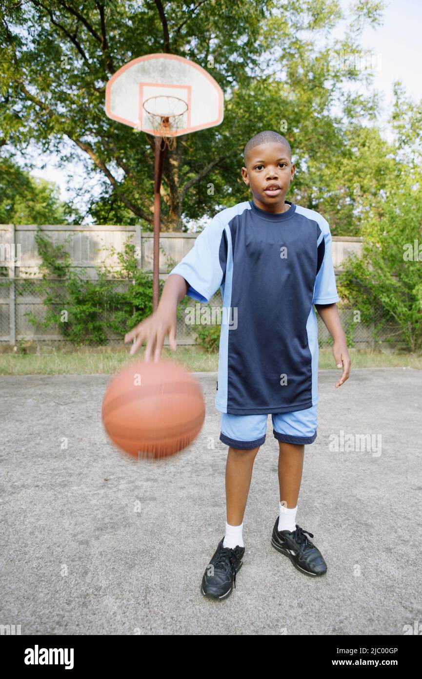 Children bouncing basketball hi-res stock photography and images - Alamy