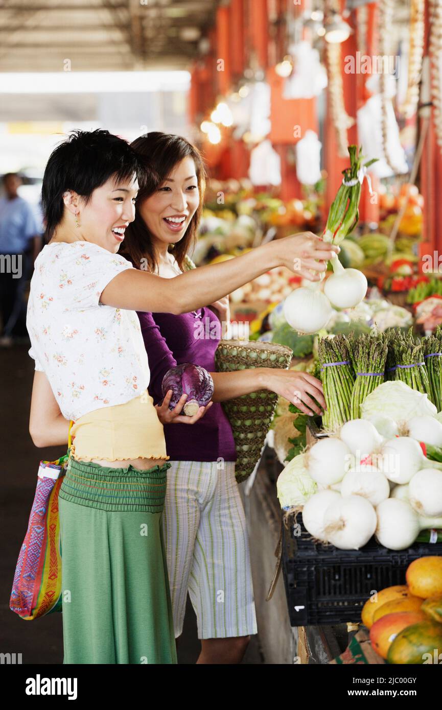 Two women shopping for produce Stock Photo - Alamy