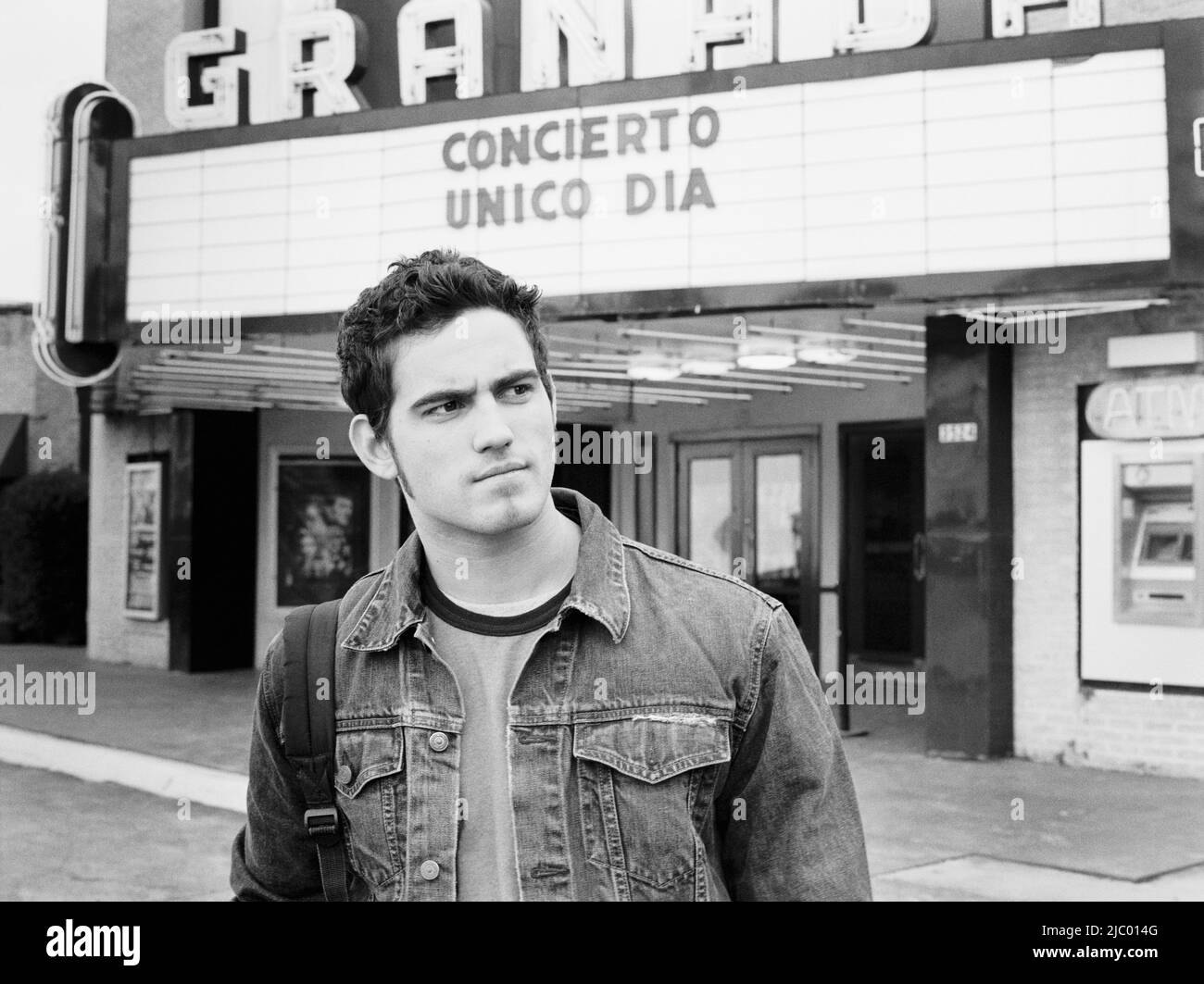 Man standing in front of movie theater Stock Photo - Alamy