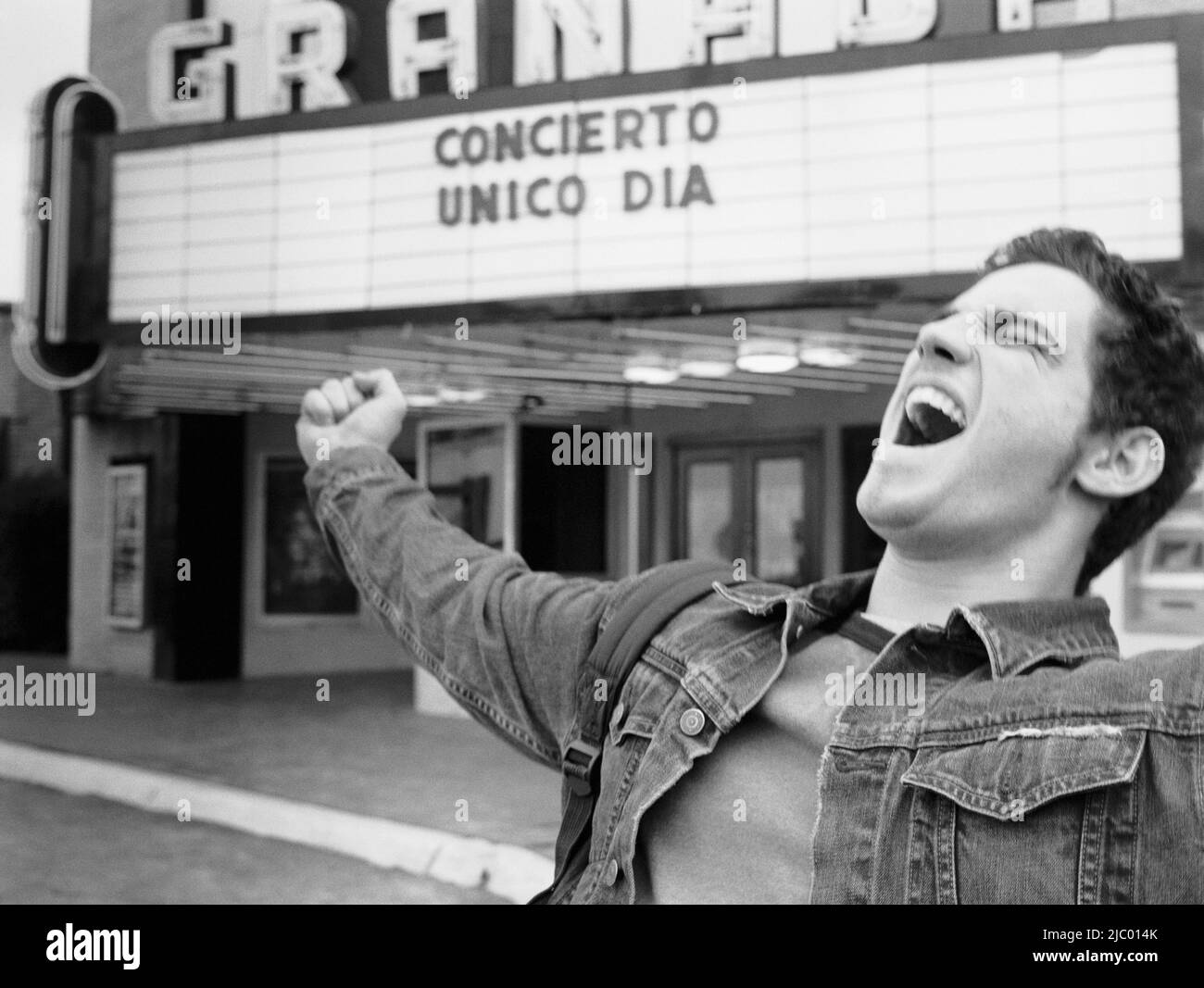 Man yelling in front of movie theater Stock Photo - Alamy