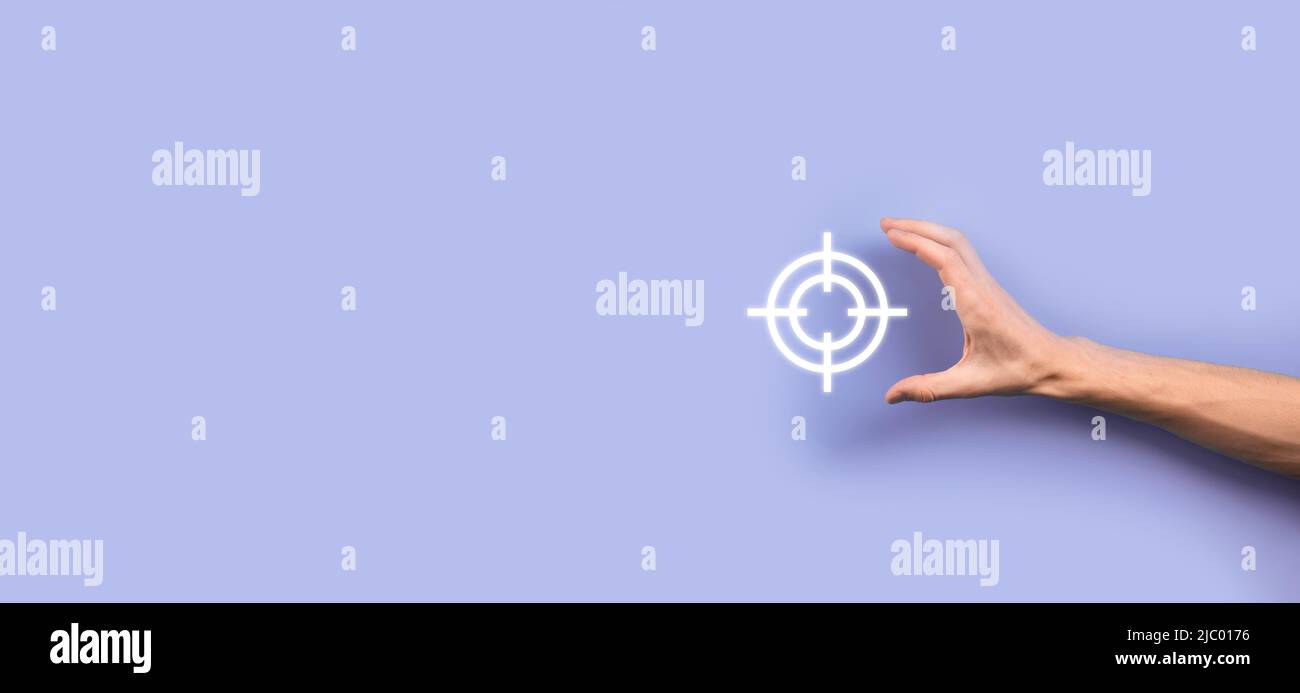Targeting concept with businessman hand holding target icon dartboard ...