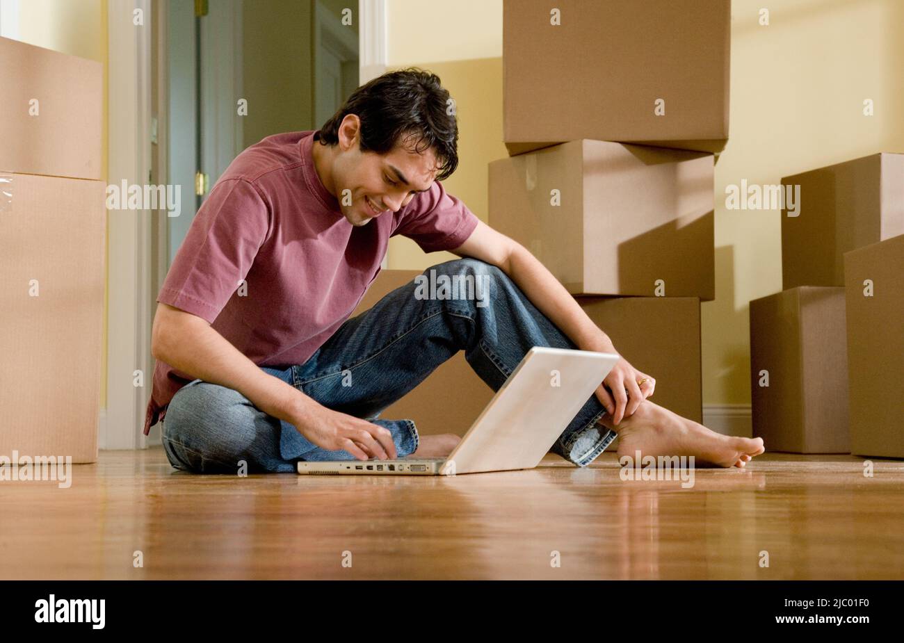 Hispanic man smiling inside new hi-res stock photography and images - Alamy