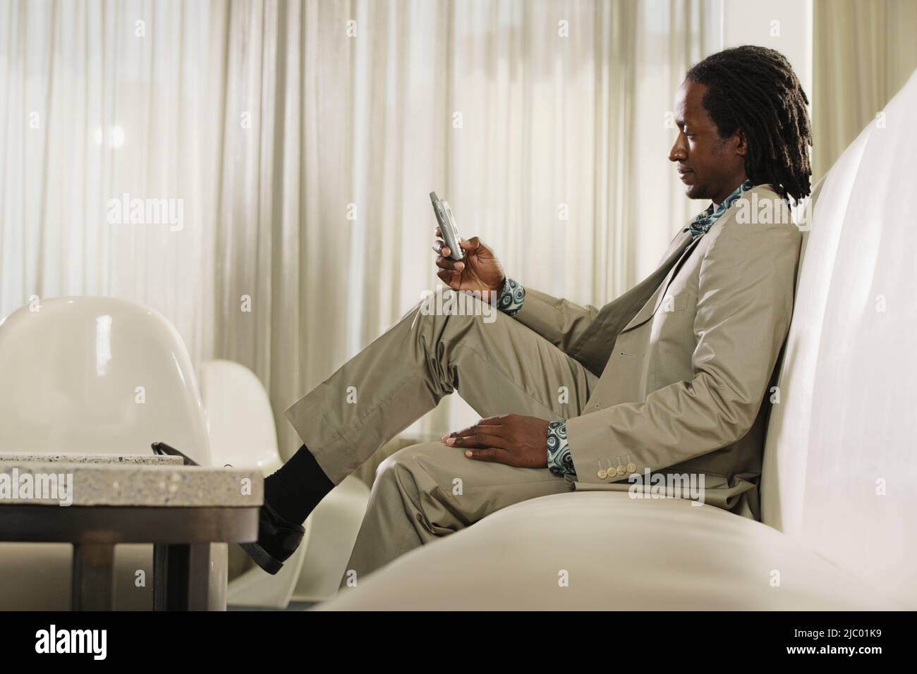 African man dialing cell phone Stock Photo - Alamy