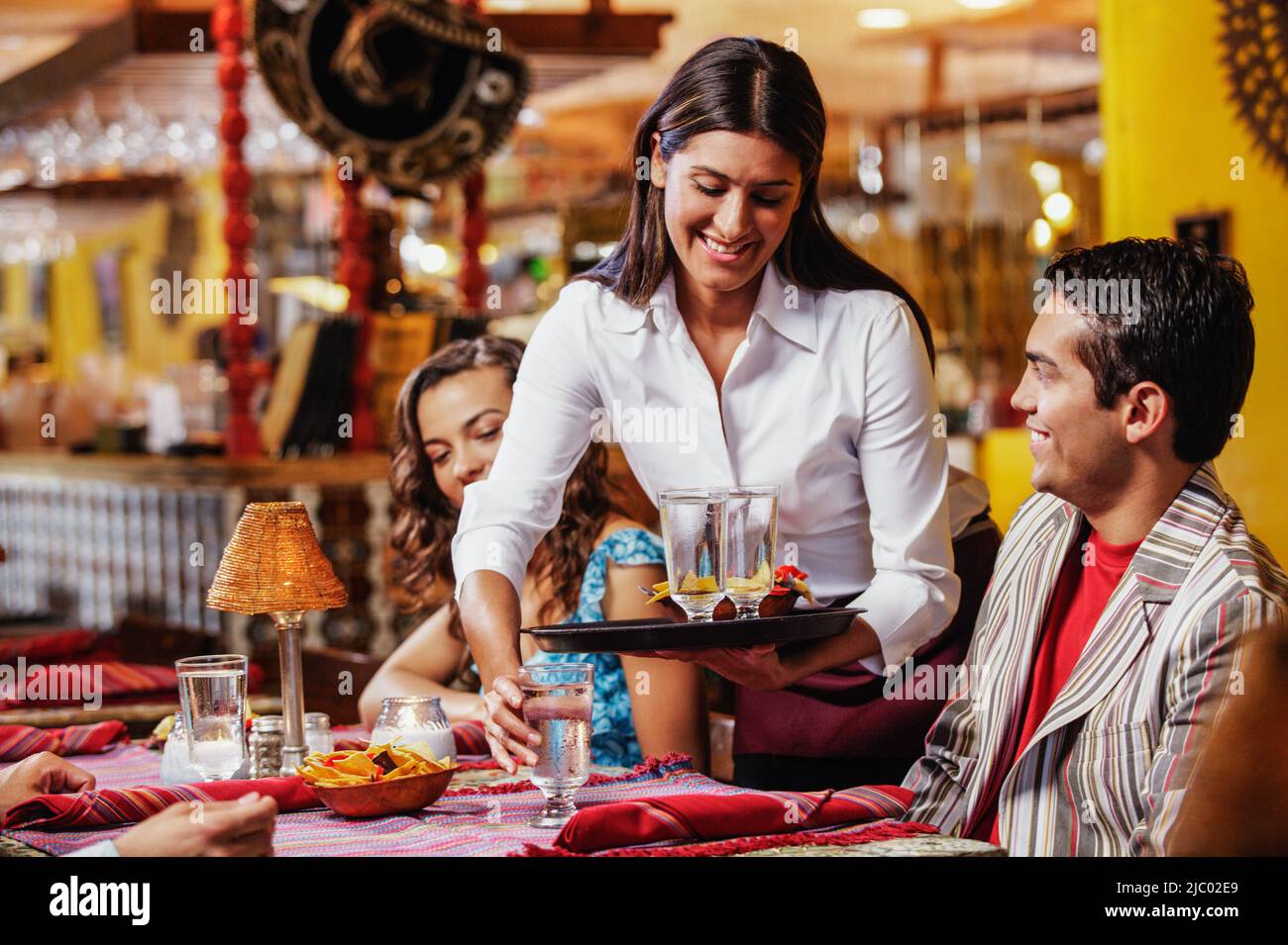 Hispanic woman female waitress server serving hi-res stock photography ...