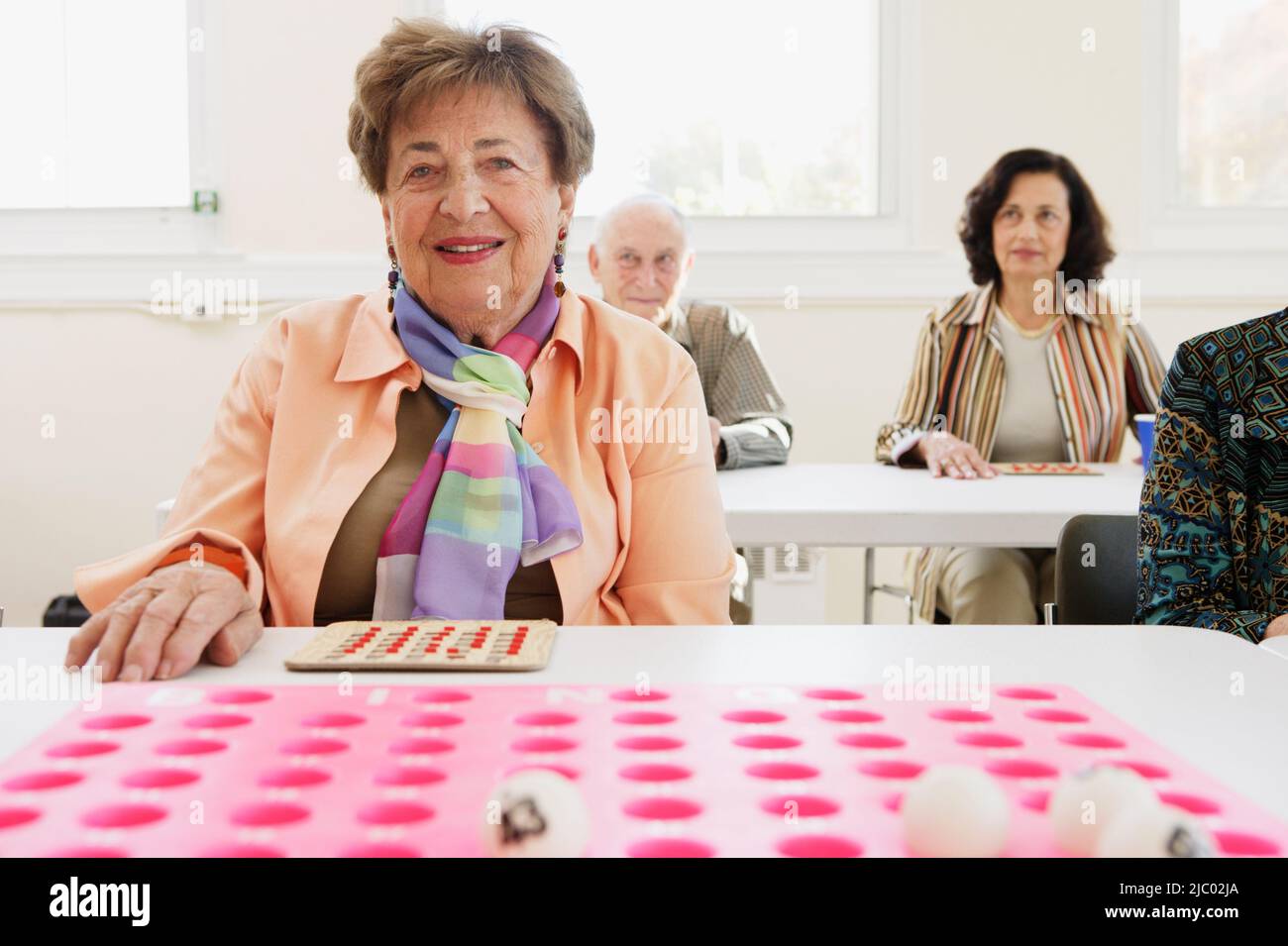 Elderly woman playing bingo Stock Photo - Alamy
