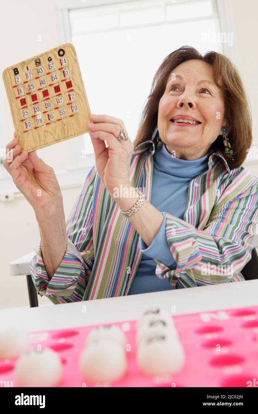 Elderly woman winning at bingo Stock Photo - Alamy