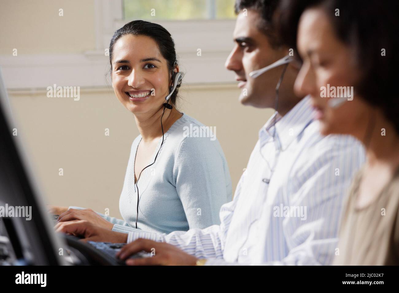 Business people headsets using computers hi-res stock photography and ...