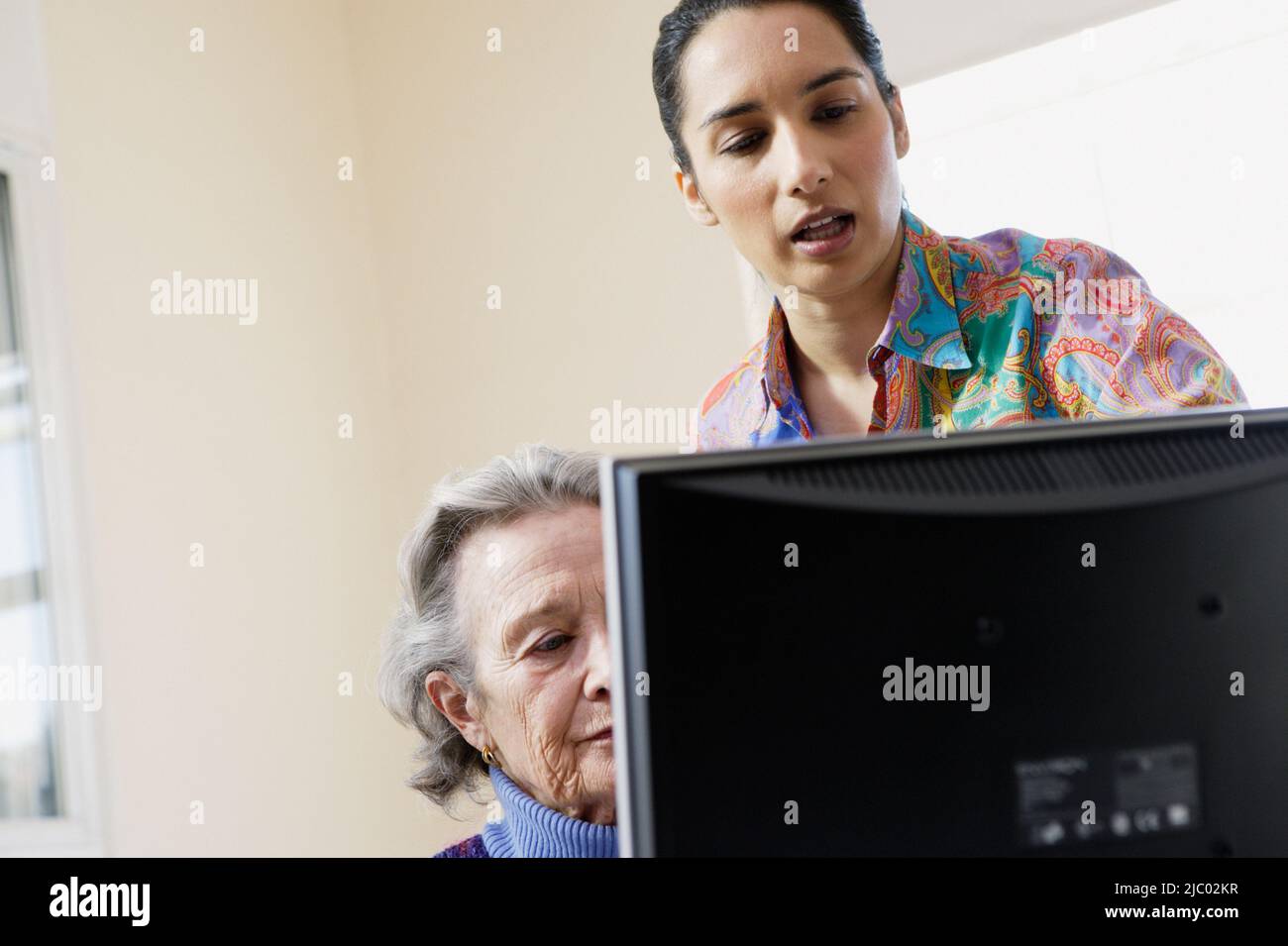 Woman teacher helping elderly hi-res stock photography and images - Alamy