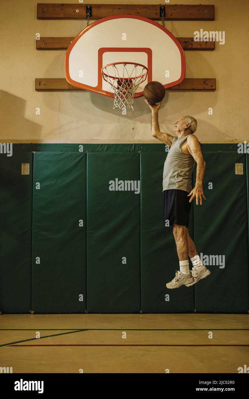 Elderly men jumping to slam dunk a basketball Stock Photo - Alamy