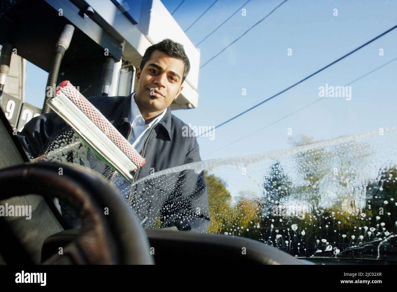 Man wiping car windshield Stock Photo - Alamy