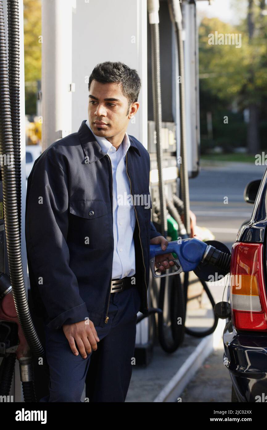 Young man pumping gas Stock Photo - Alamy