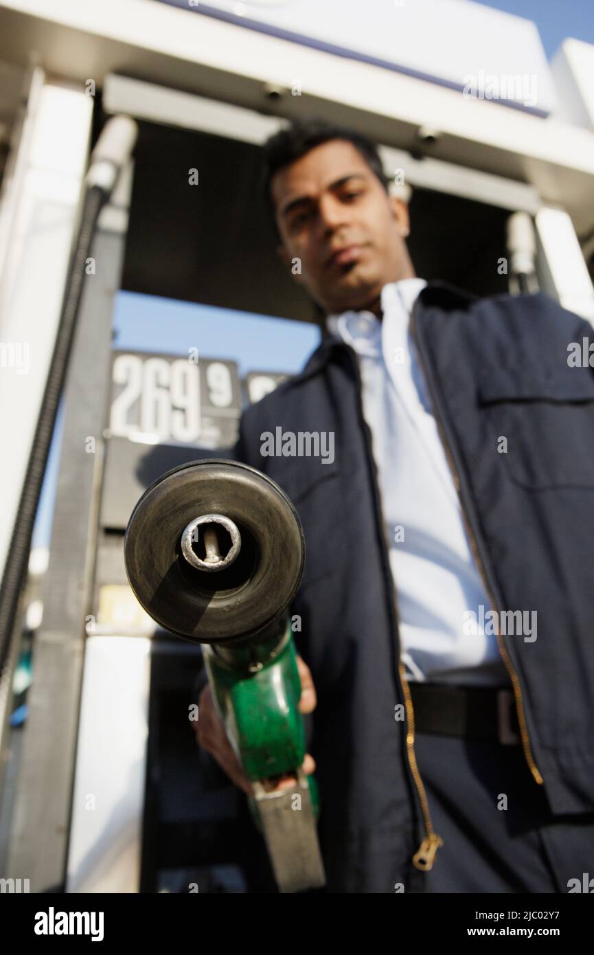 Young man pumping gas Stock Photo - Alamy