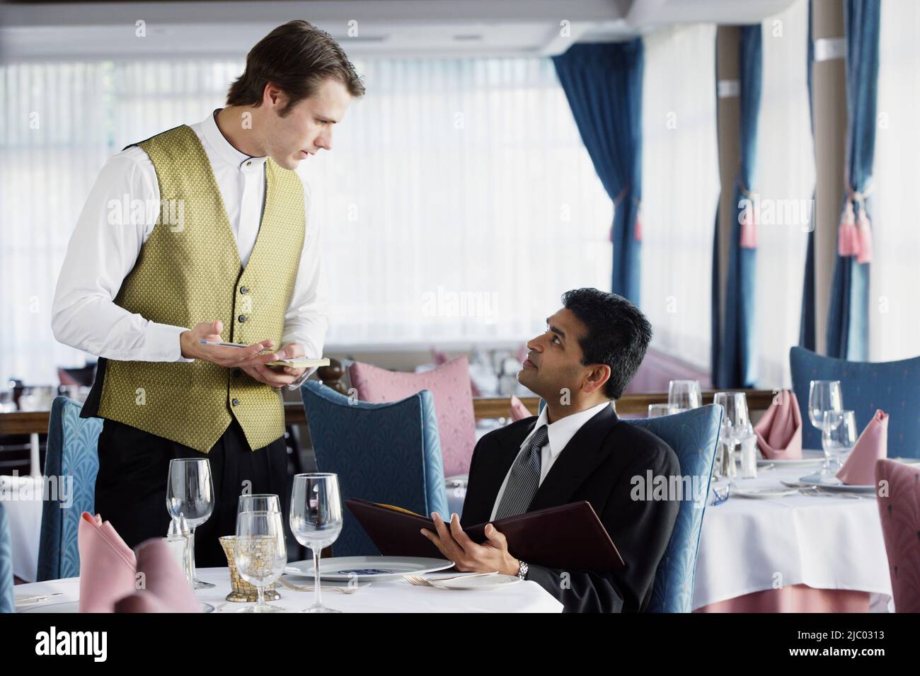 Man ordering food in a restaurant Stock Photo - Alamy