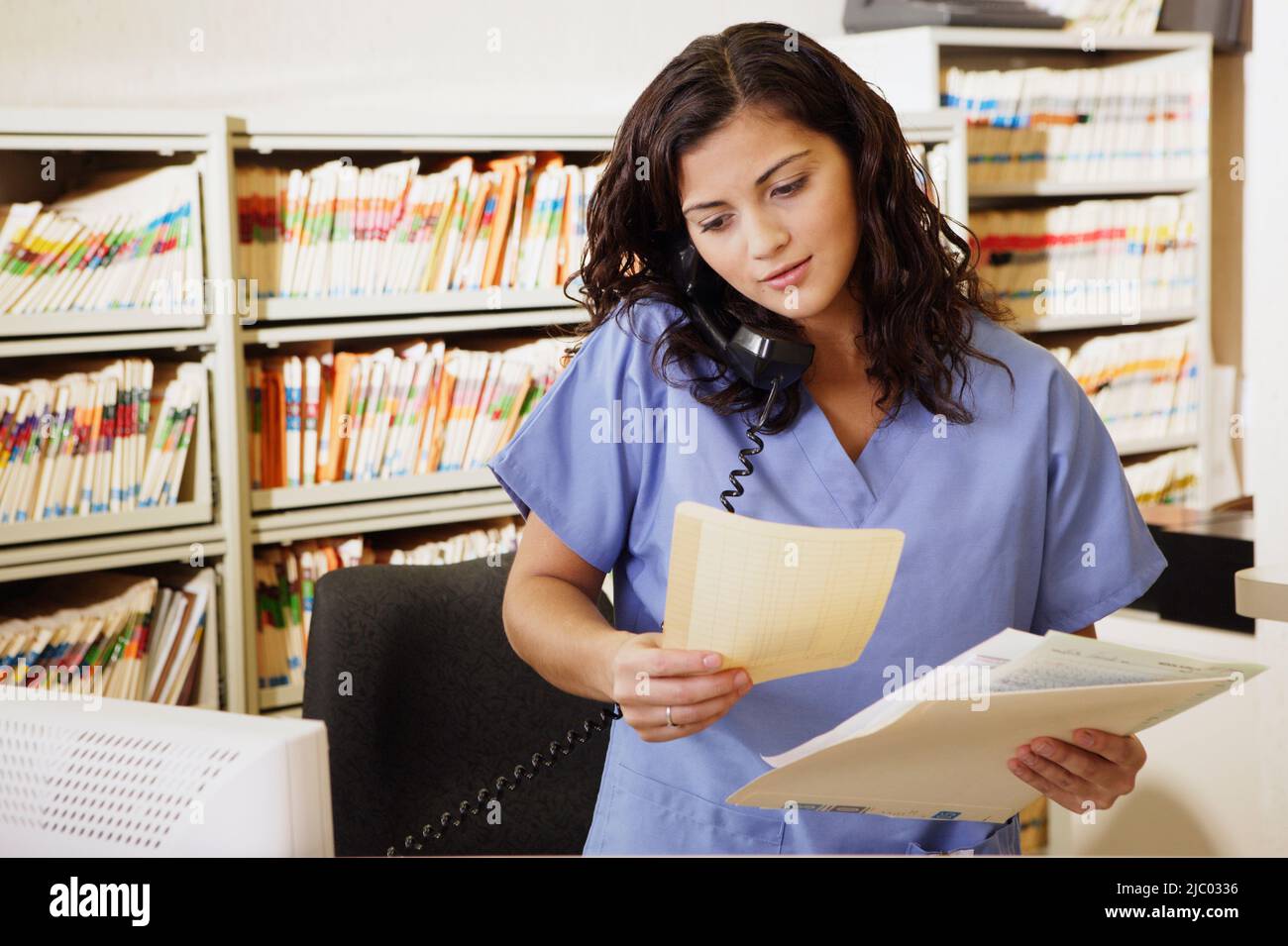 Nurse answering the phone in hospital Stock Photo - Alamy