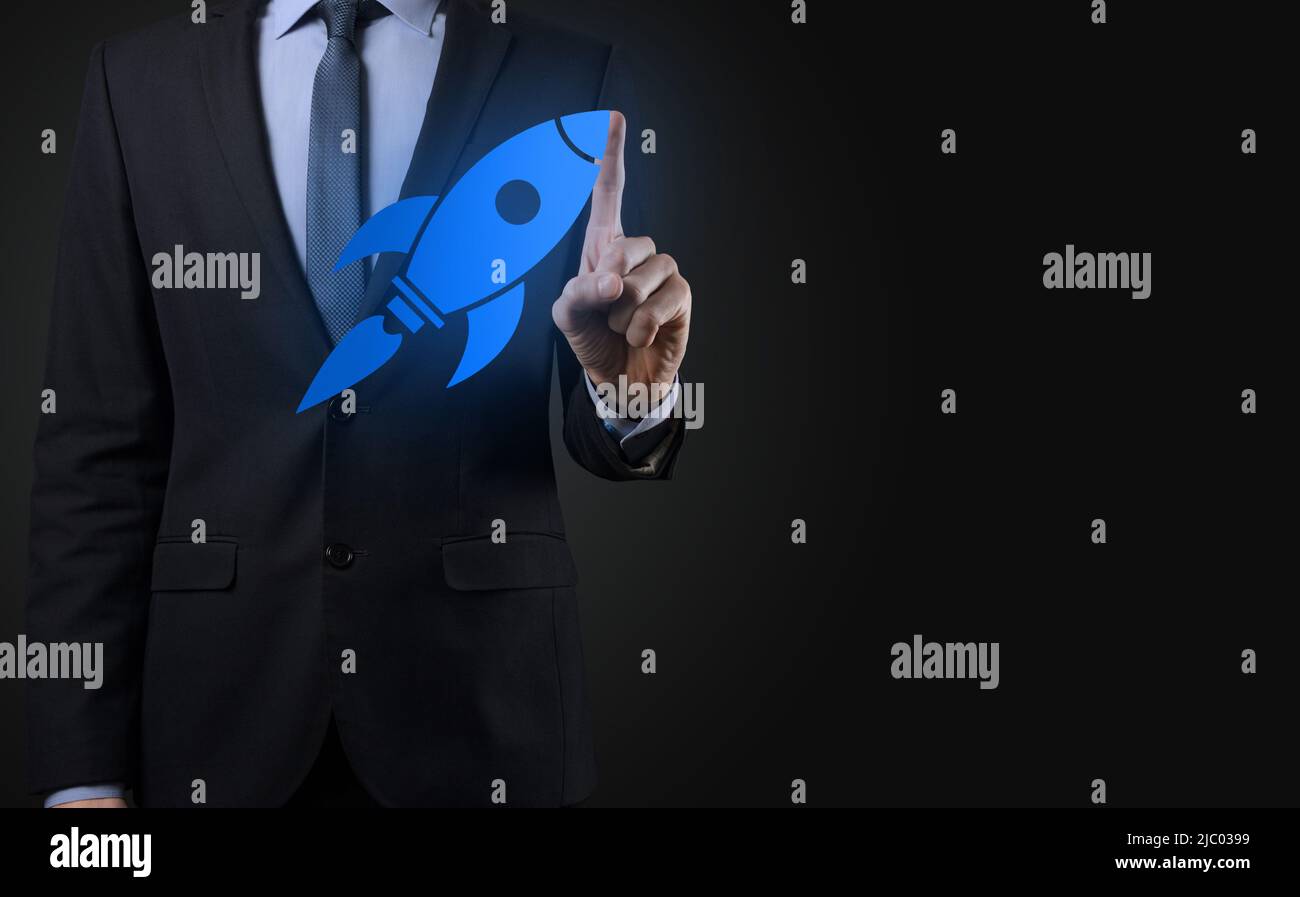 Start up concept with businessman holding abstract digital rocket icon ...