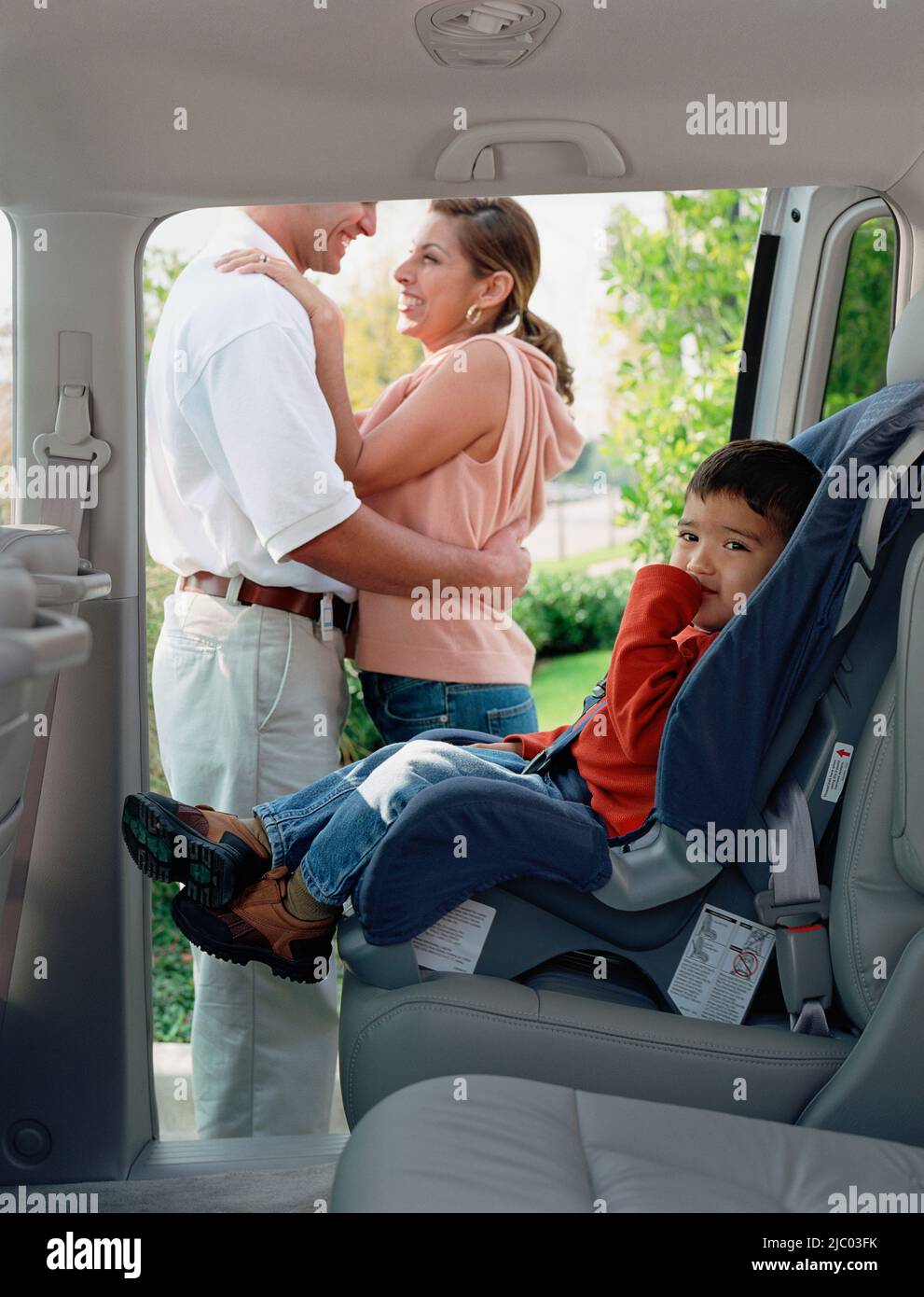Couple hugging by their car Stock Photo - Alamy