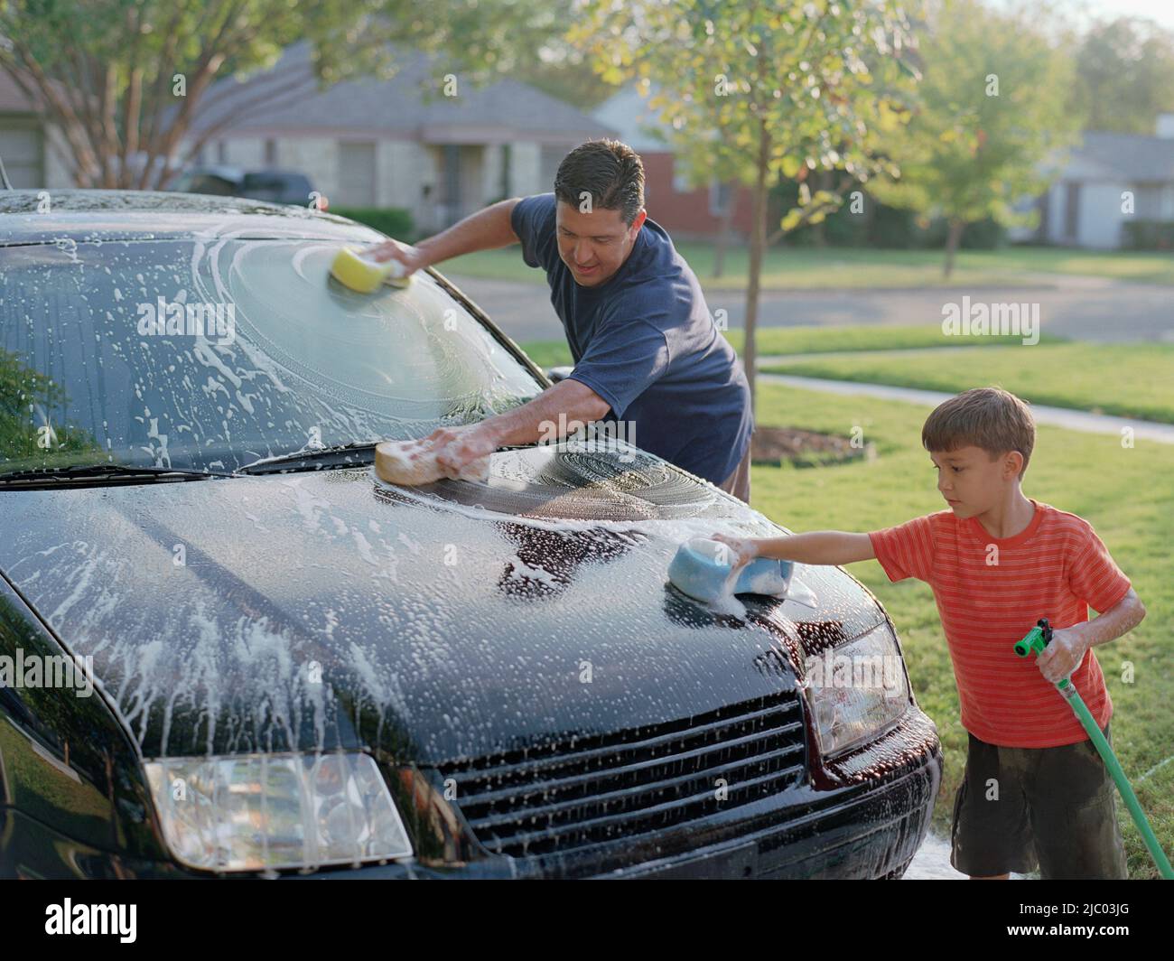 Male children washing car hi-res stock photography and images - Alamy