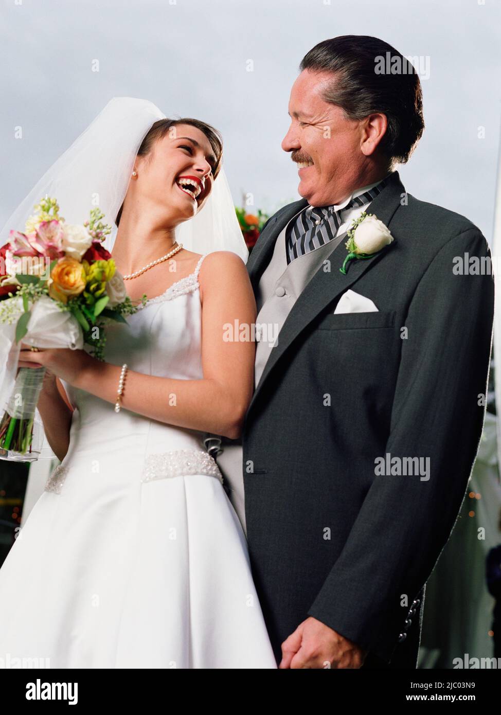 Bride posing for the camera with her father Stock Photo - Alamy
