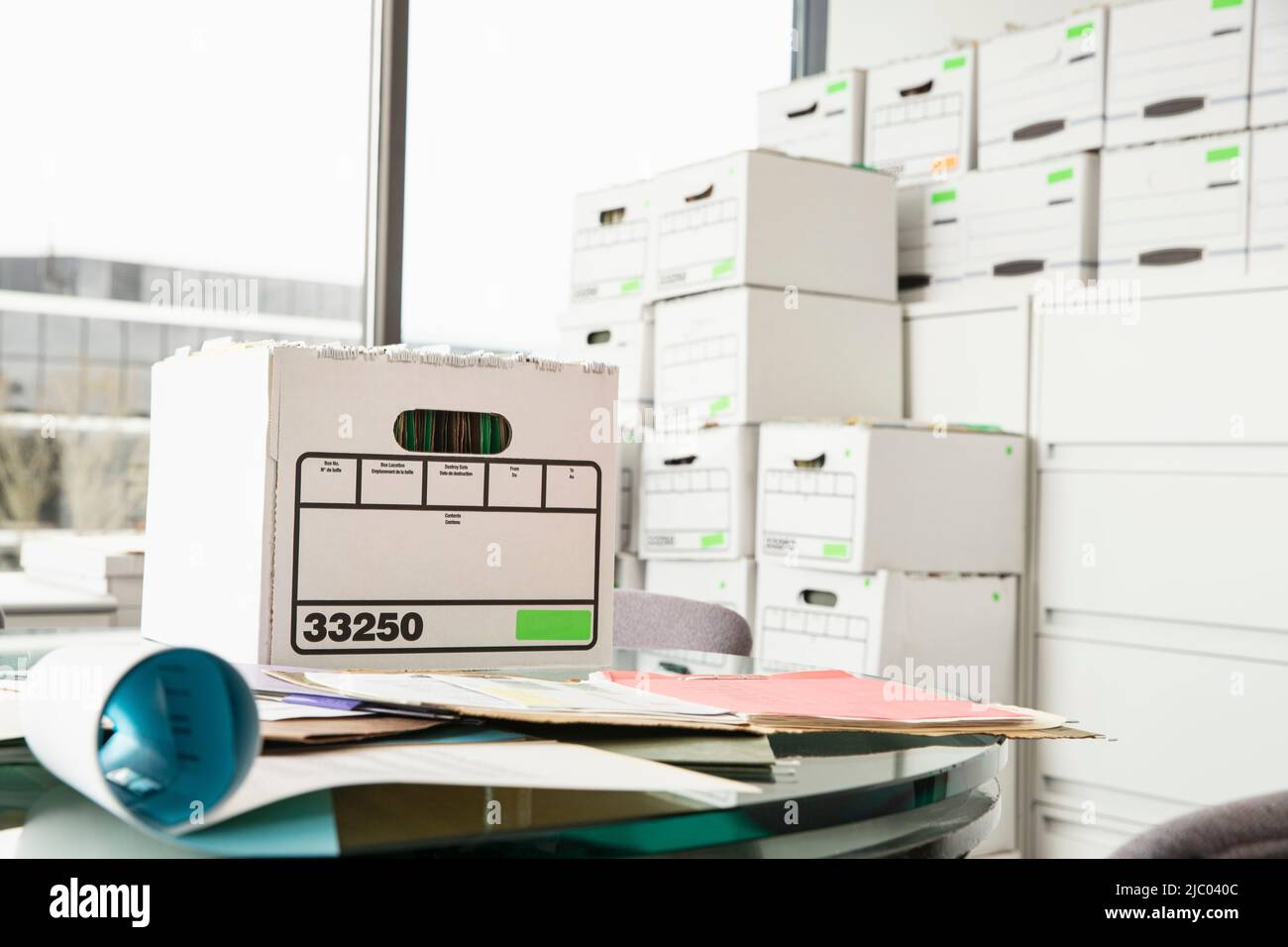 Empty shot of files and boxes sitting on a table Stock Photo - Alamy