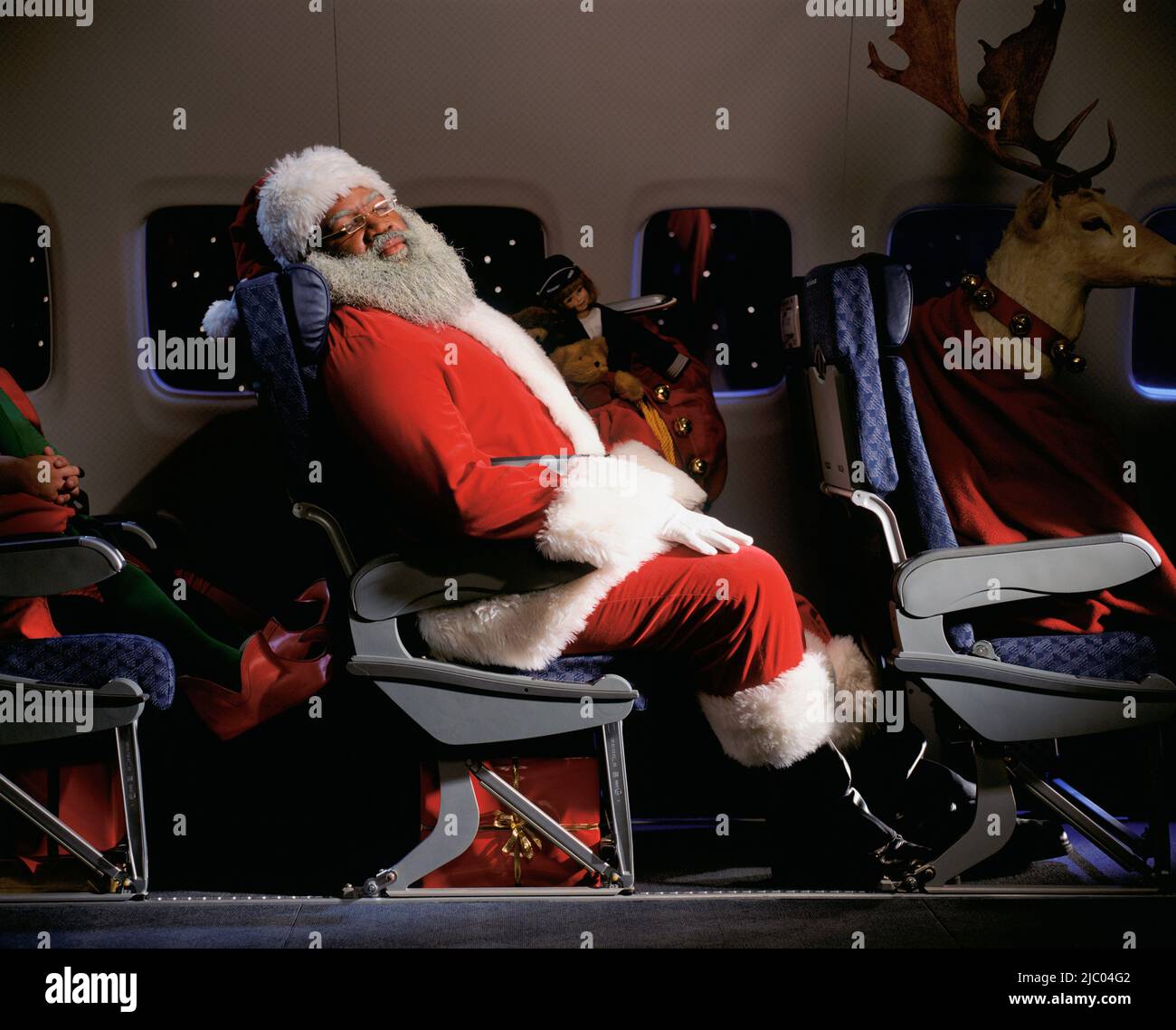 Santa Clause, reindeer and presents on an airplane Stock Photo - Alamy