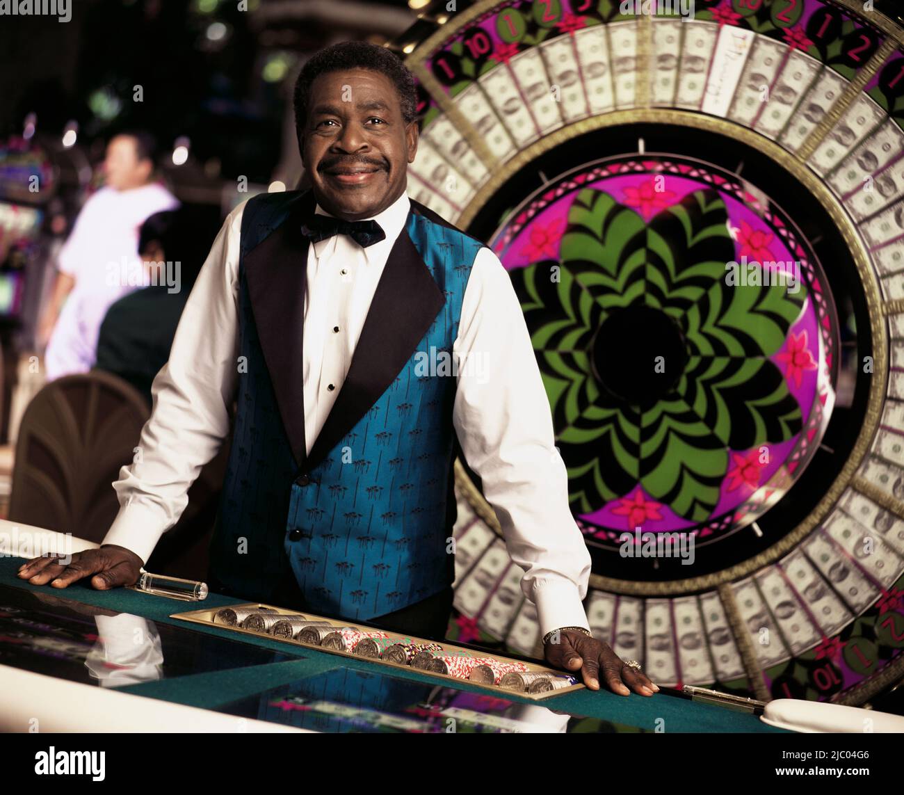 Male dealer at roulette wheel Stock Photo - Alamy