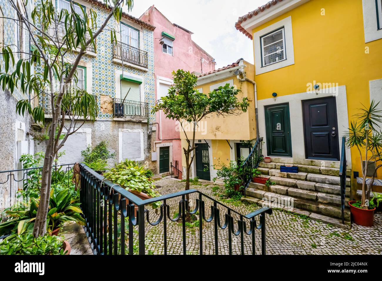 Old houses surrounded a cobbled courtyard in the centre of Lisbon ...