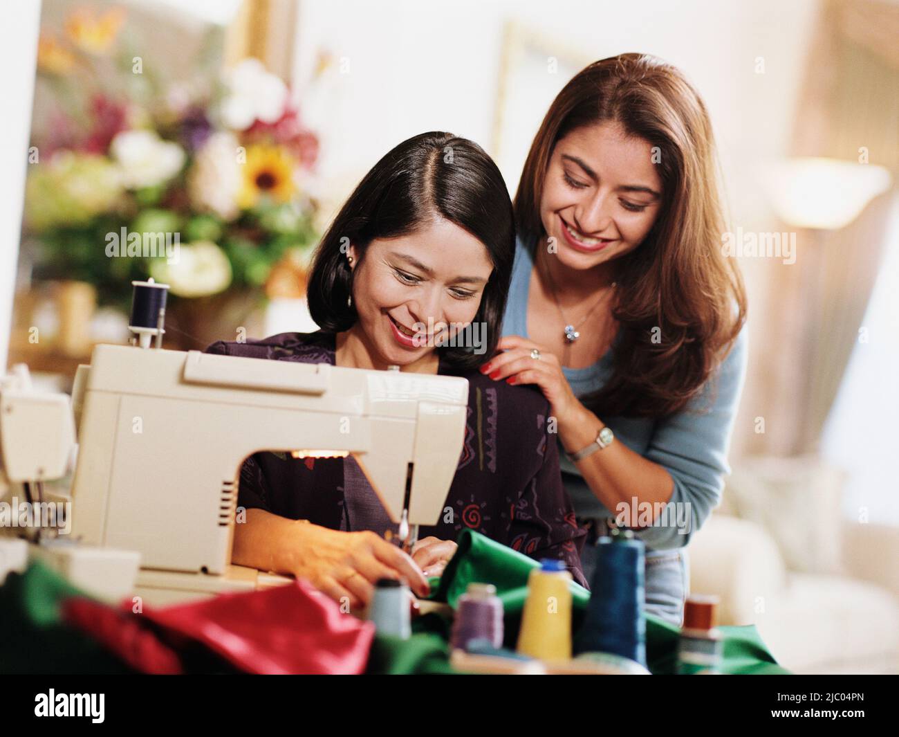 Mother and daughter working on sewing project Stock Photo - Alamy