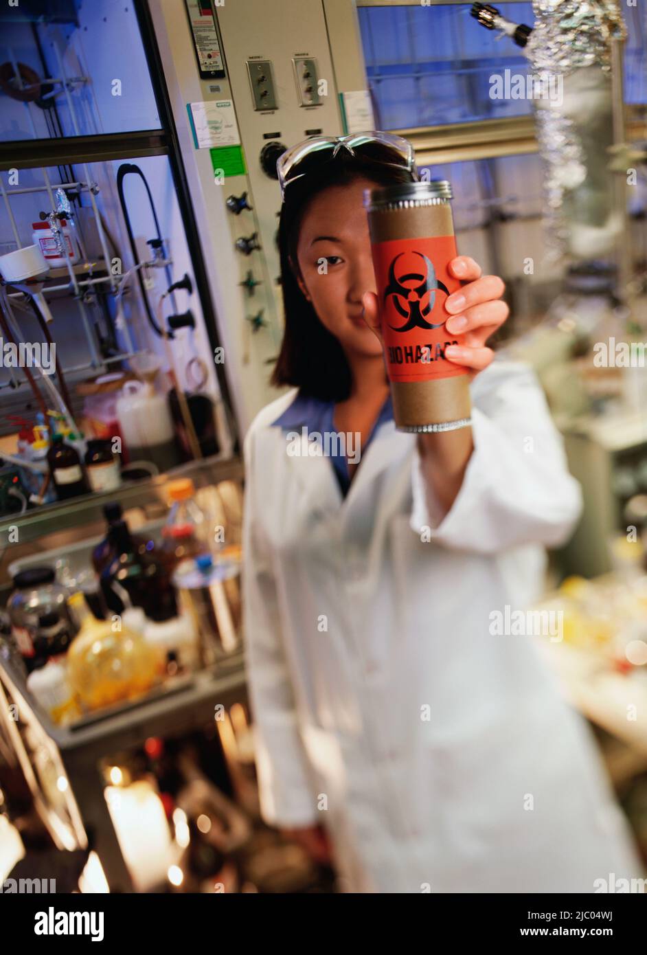 Female scientist holding container of toxic material Stock Photo - Alamy