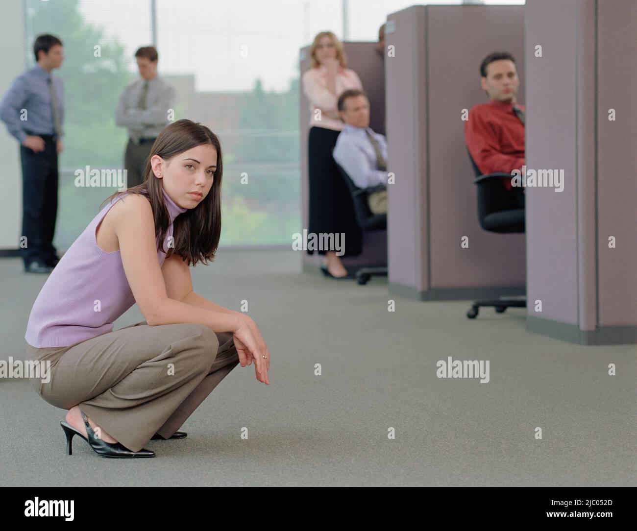 Businesswoman squatting on the floor of office Stock Photo - Alamy