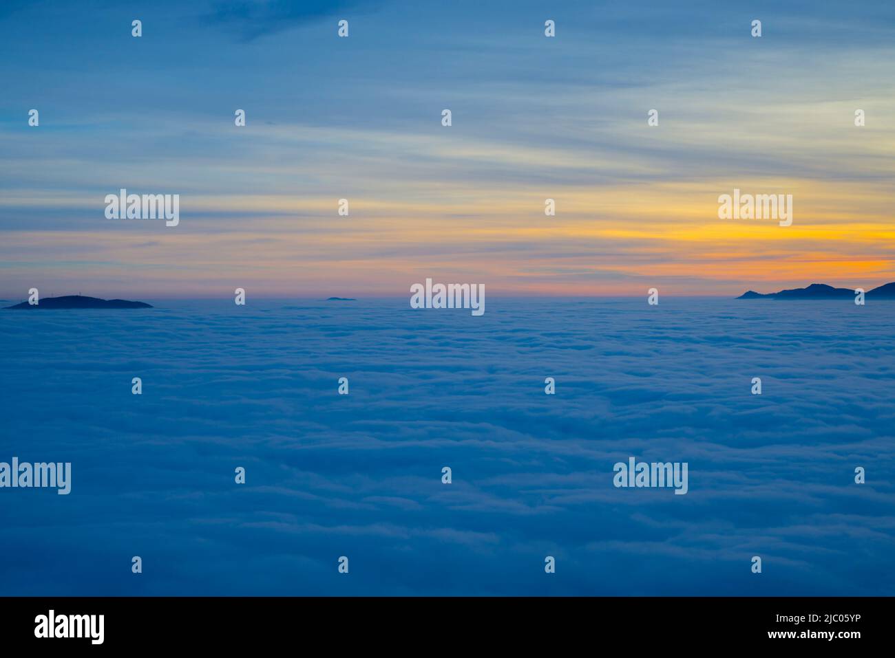 Aerial View over Snow-capped Mountain Above Cloudscape in Dusk in ...