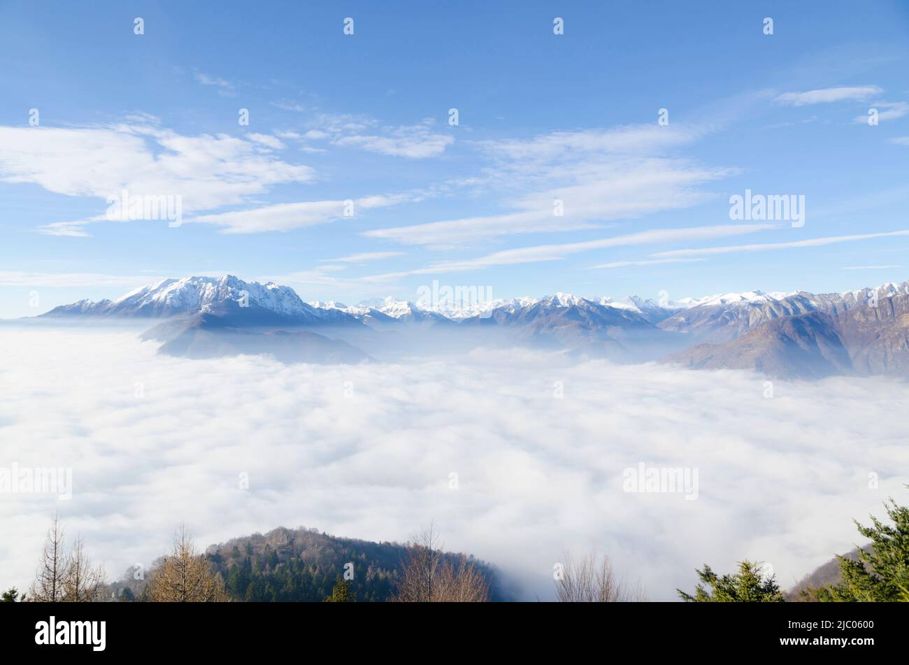 Aerial View over Snow-capped Mountain Above Cloudscape in a Sunny Day ...