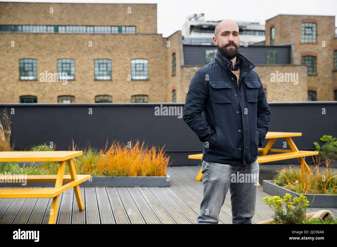Portrait of man on rooftop patio Stock Photo - Alamy