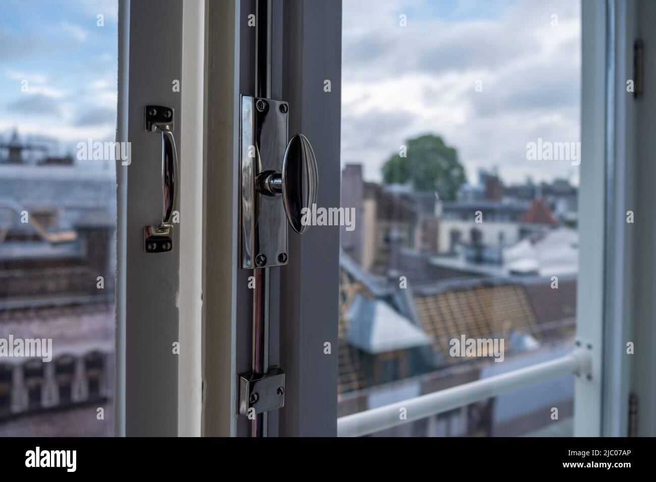 White wooden window and knob close up view. Retro glass window open ...