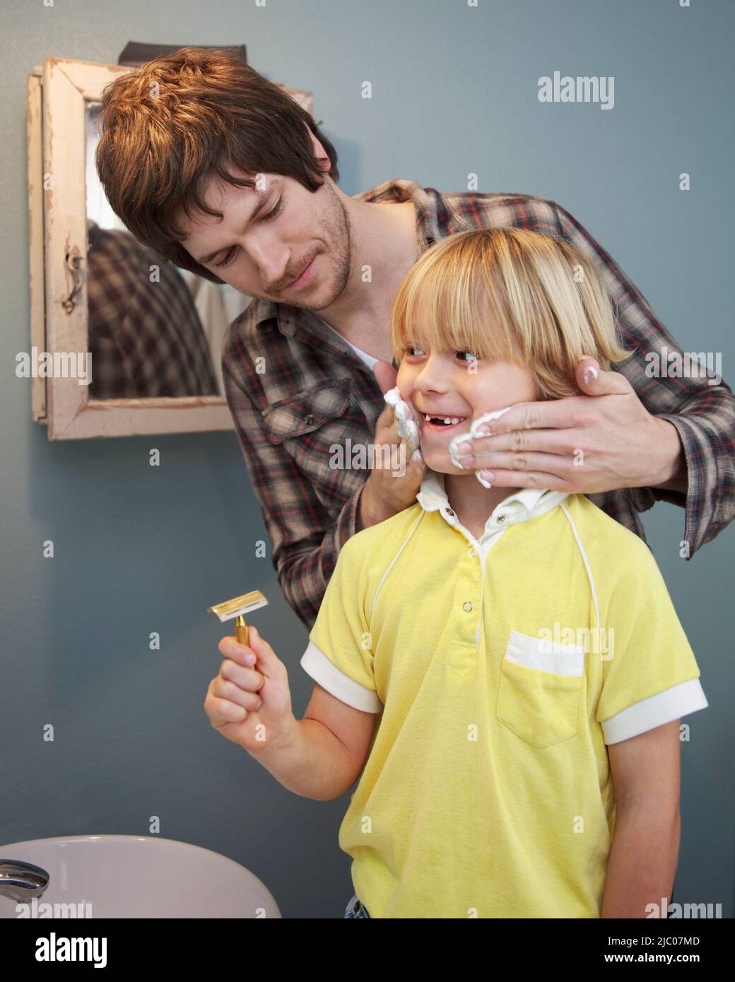 Father son applying shaving cream hi-res stock photography and images ...