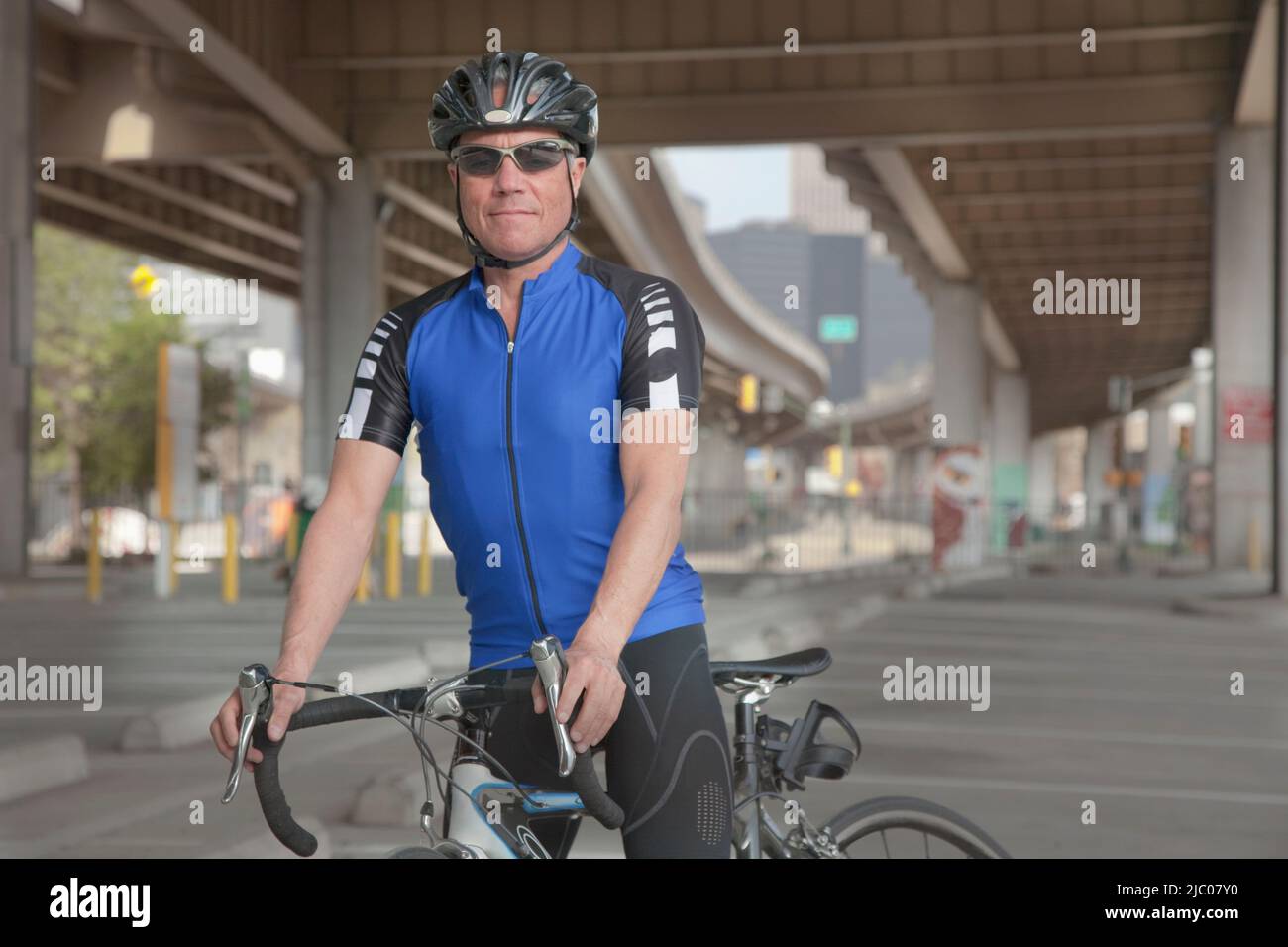 Portrait of a cyclist with his bicycle Stock Photo - Alamy