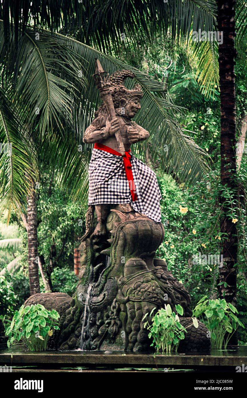 Statue of a warrior wearing a checkered skirt conquering lion in the ...
