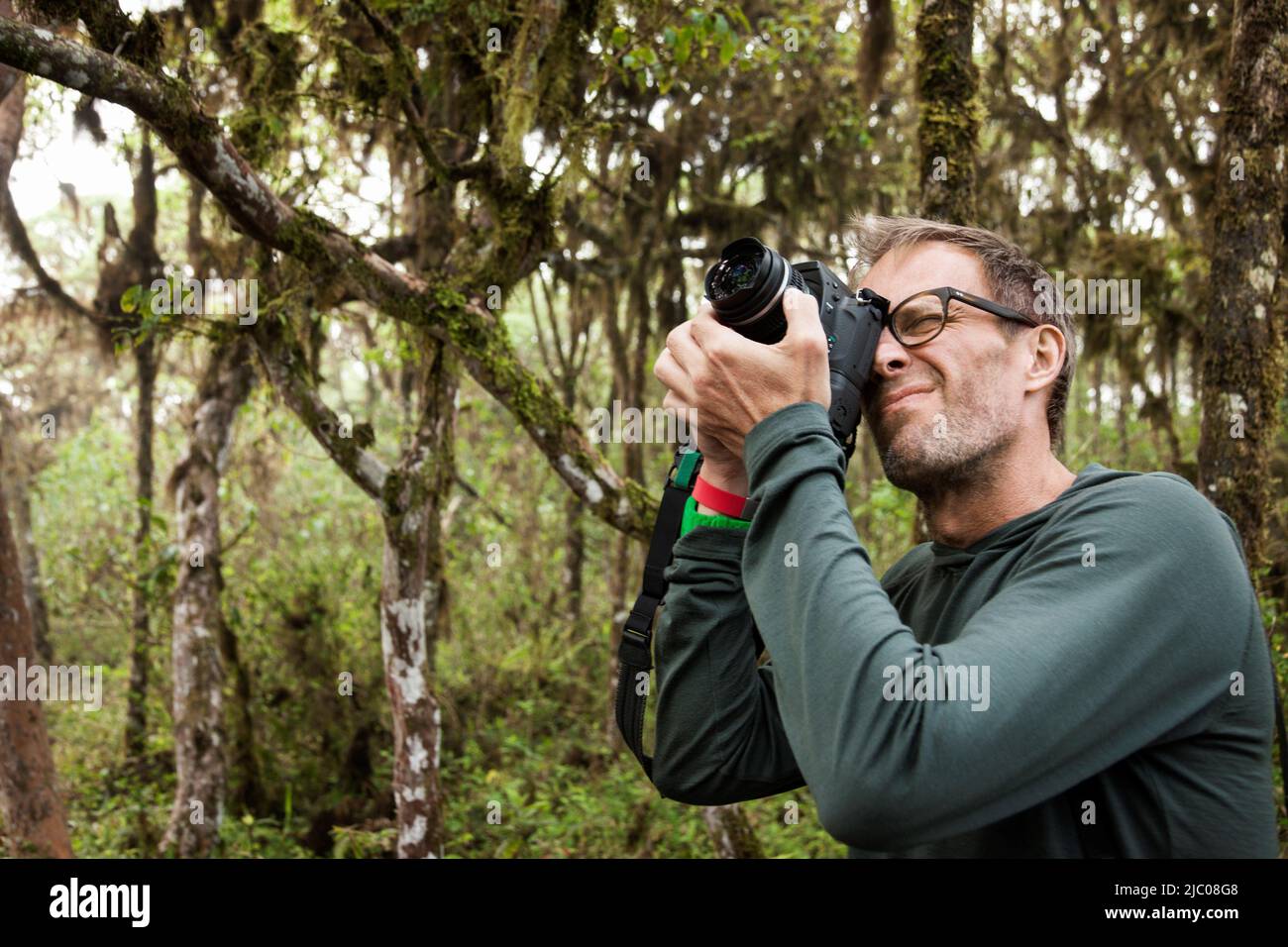 Man photographing camera in moss hi-res stock photography and images ...