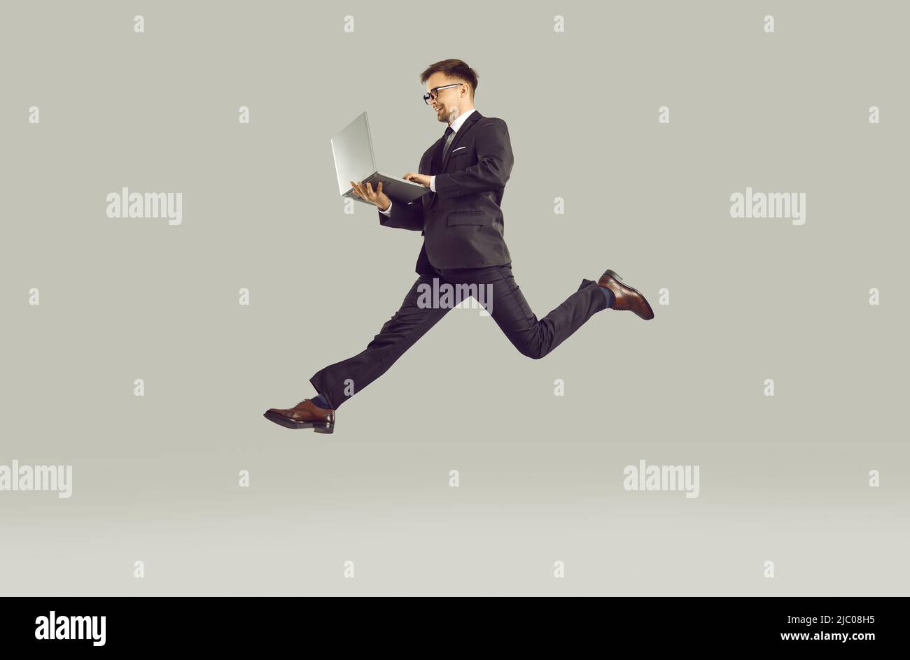 Successful young businessman who is in hurry to do lot of work working ...