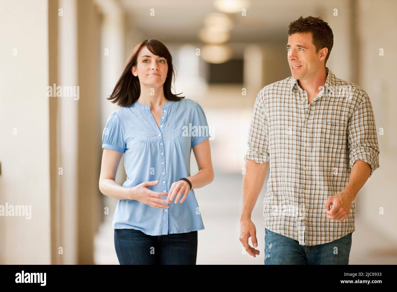 Couple walking in a corridor Stock Photo - Alamy