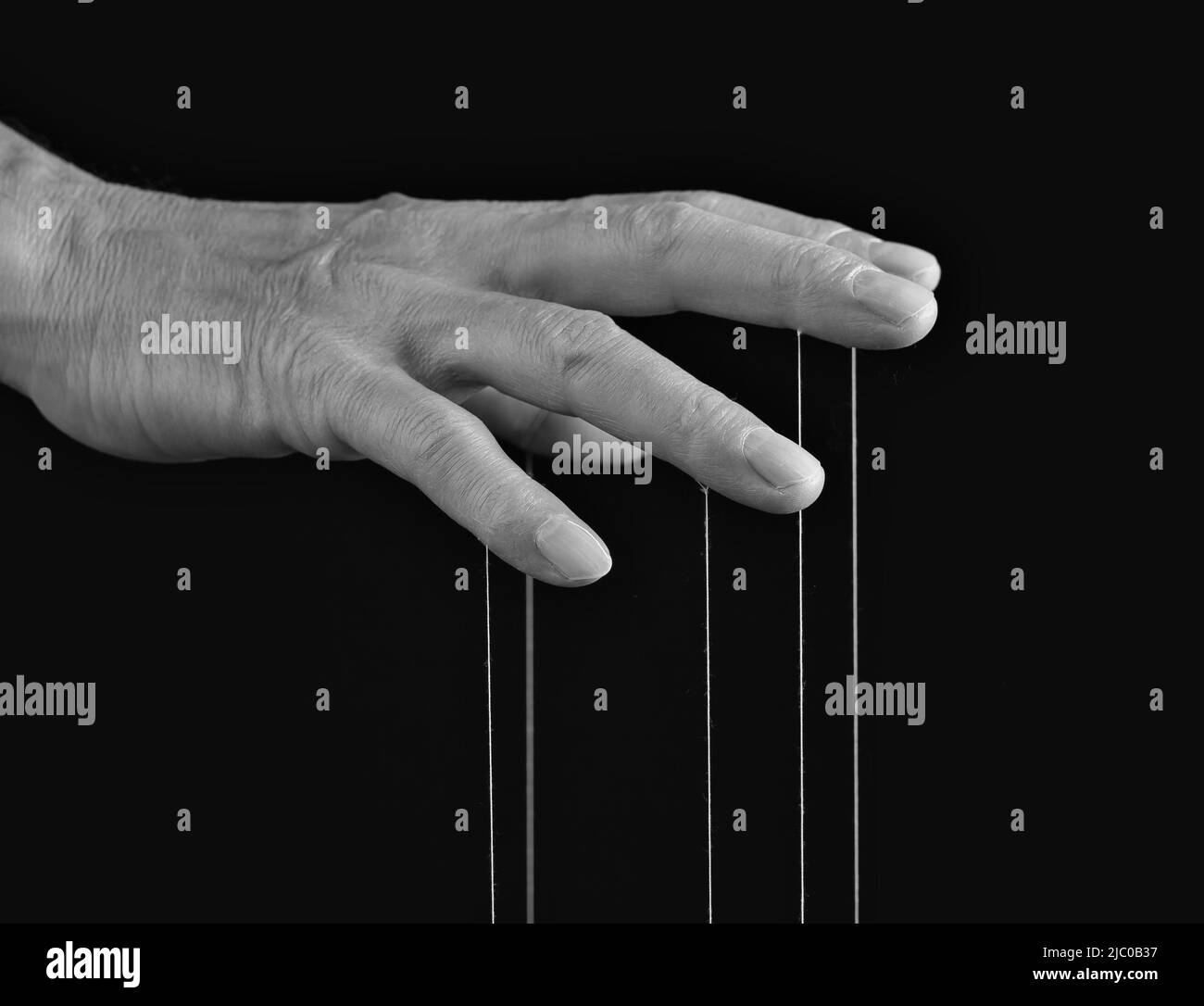 Influence, manipulation concept. Man hand with strings on fingers ...