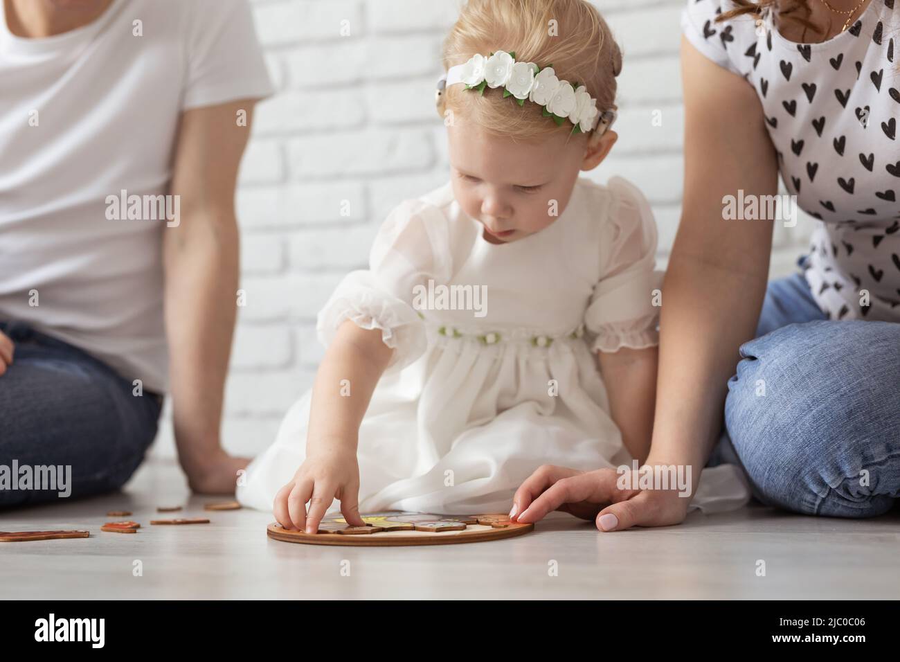 Baby child with hearing aids and cochlear implants plays with parents ...