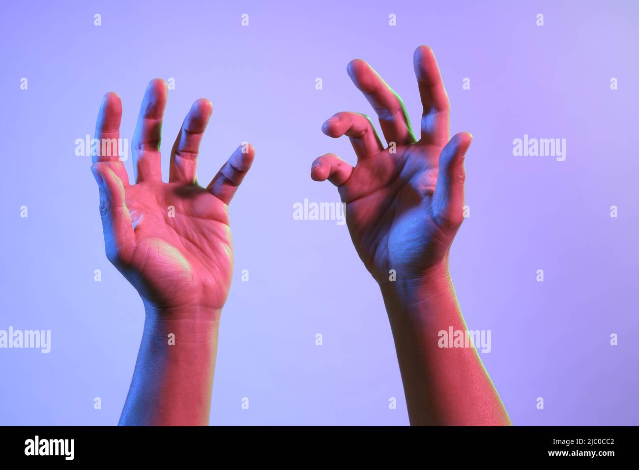 The Asian man s hands under the vivid color lighs Stock Photo - Alamy