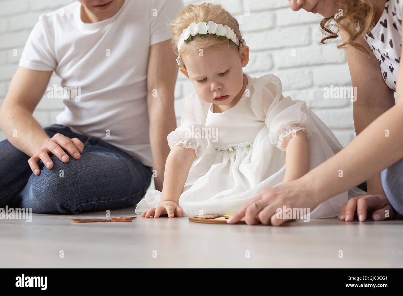 Baby child with hearing aids and cochlear implants plays with parents ...