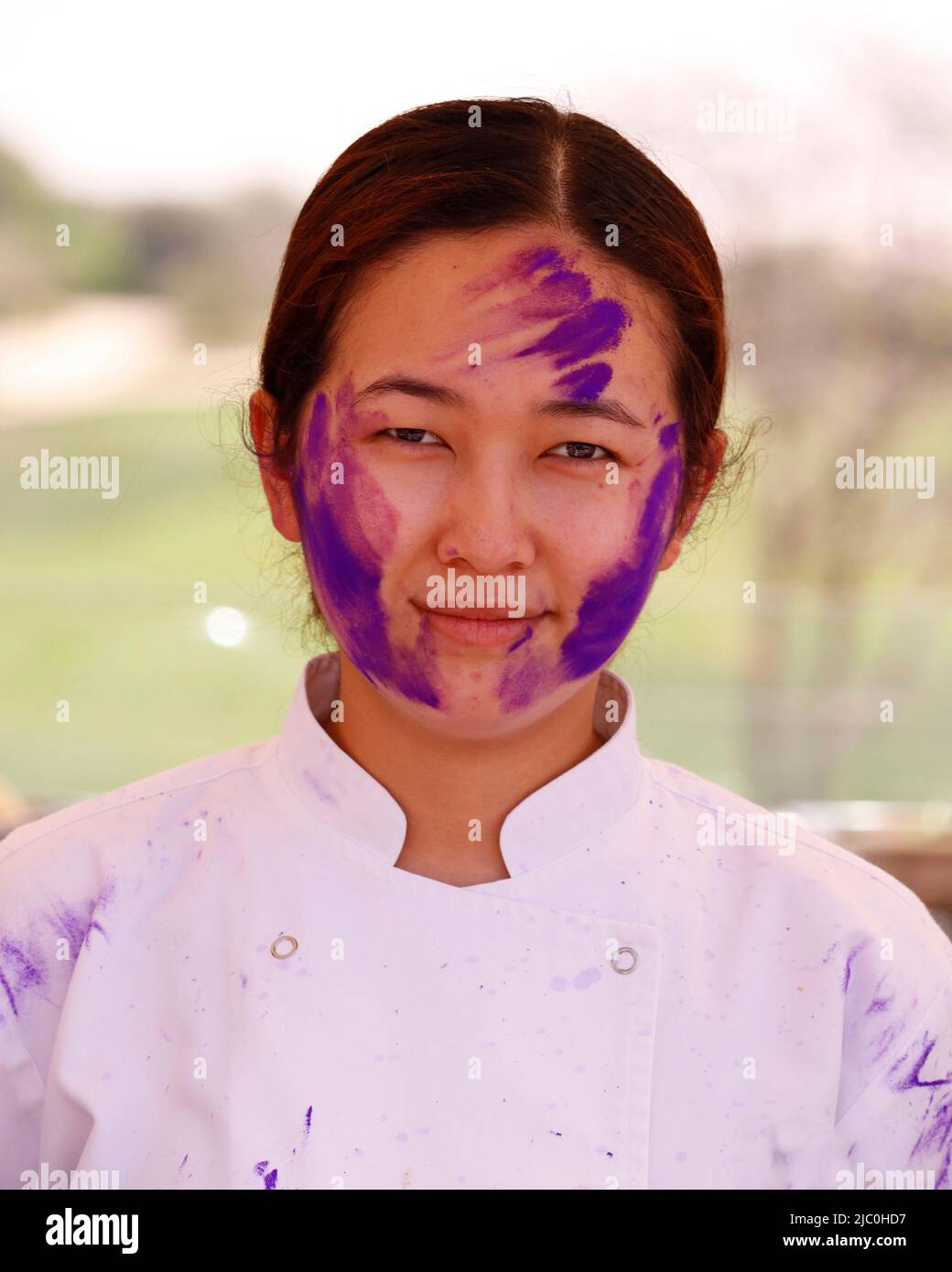 young indian lady celebrating colors of festival ( holi) in working ...
