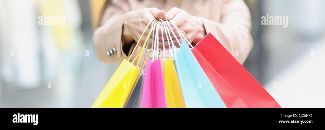 Lady wear face mask and hold bunch of packages after whole day shopping ...